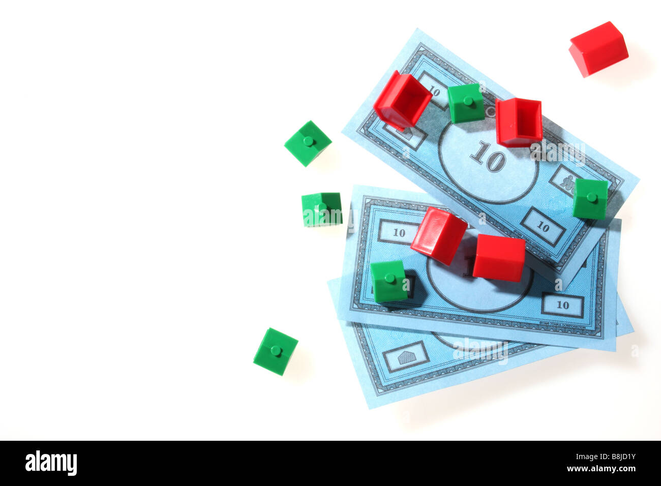 Monopoly houses and hotels on top of toy bank notes Stock Photo - Alamy