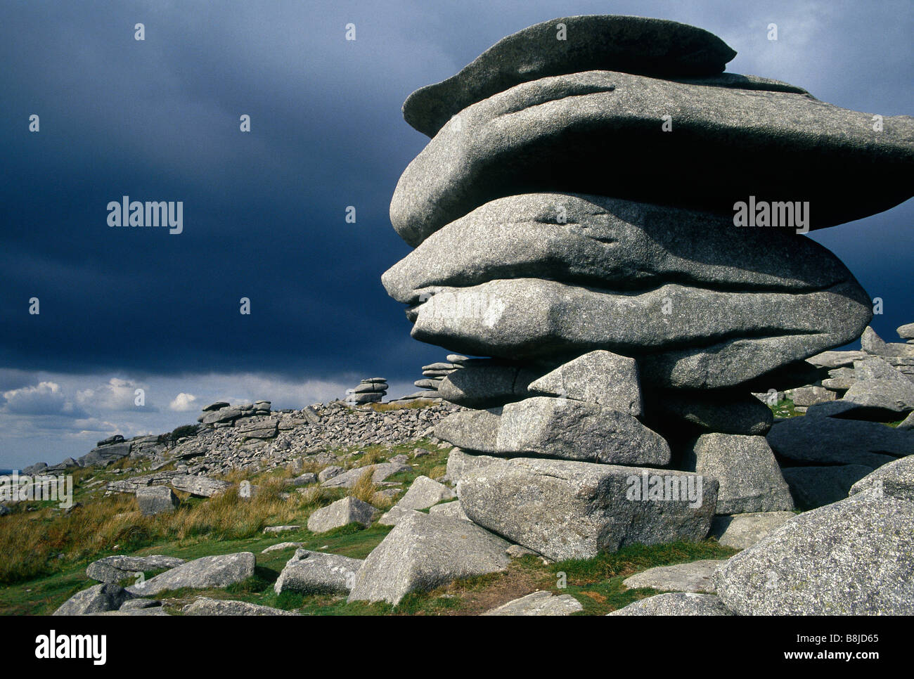 The Cheesewring Large rocks balancing on each other Grass cloudy sky ...