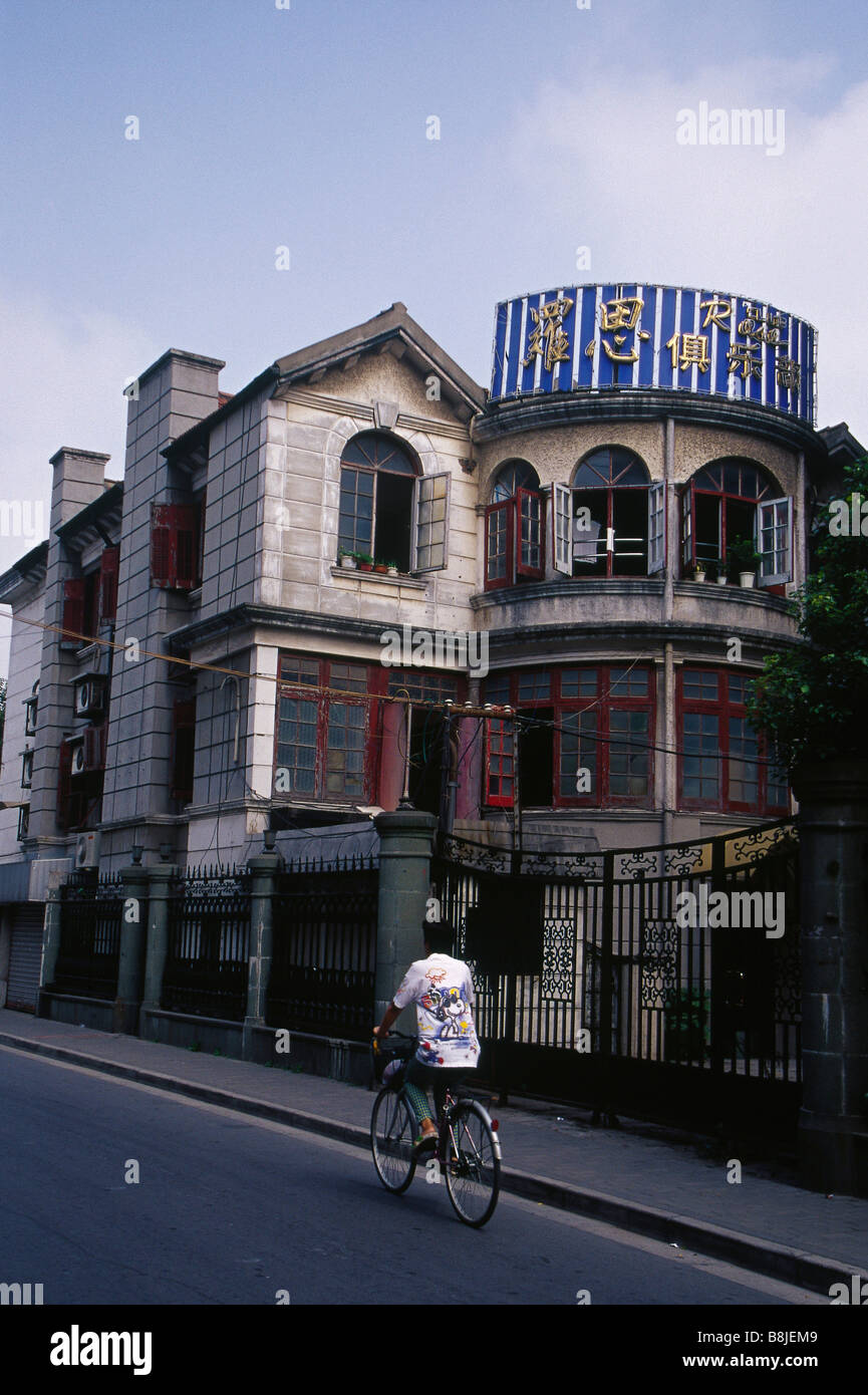 Street Old house Colonial influence Signs Man on bicycle SHANGHAI CHINA ...