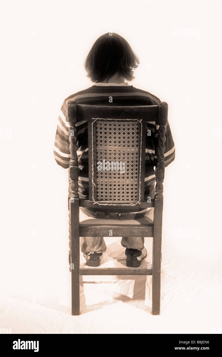 A man seated with his back to viewer Stock Photo - Alamy