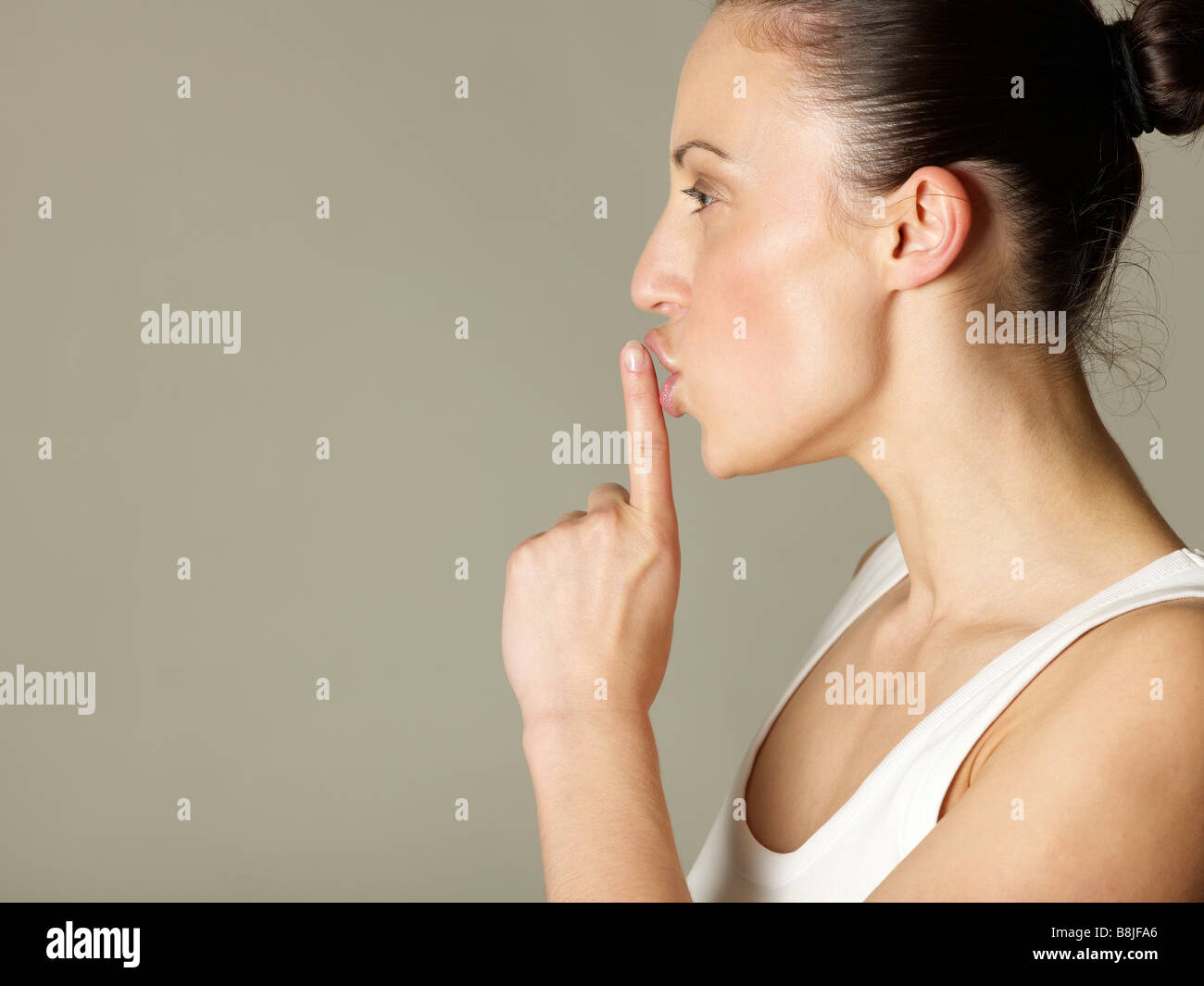 woman finger on lips shhhh Stock Photo - Alamy