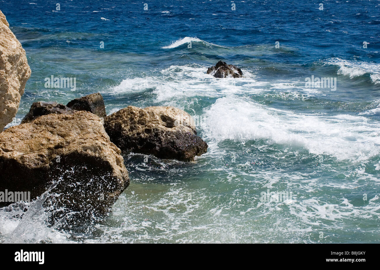 Sea spray and splashing on rocks Stock Photo - Alamy