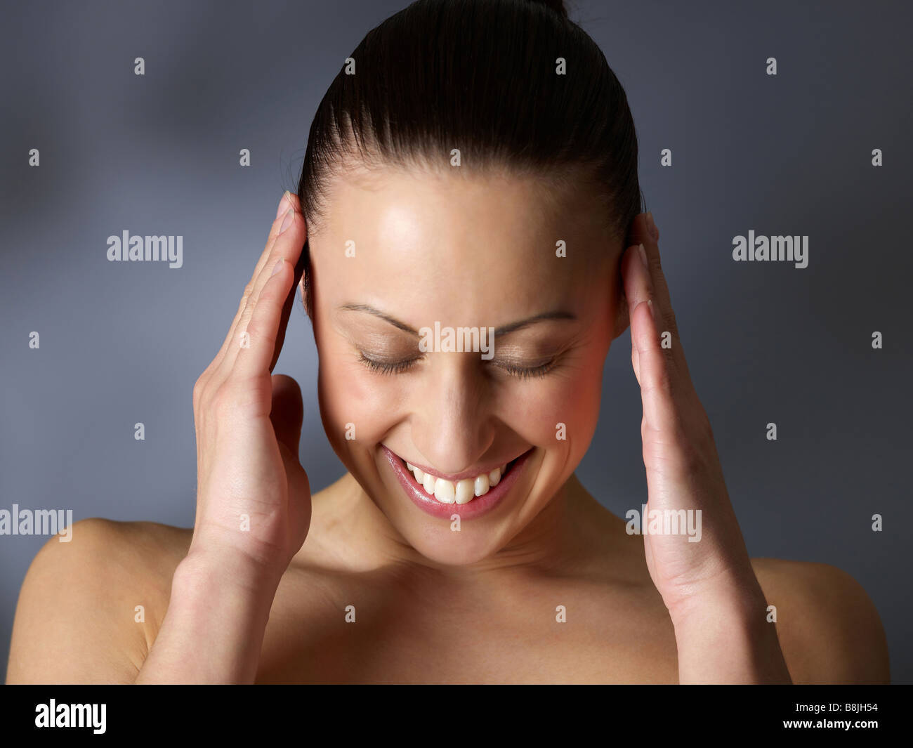 Girl in touching her temples Stock Photo - Alamy