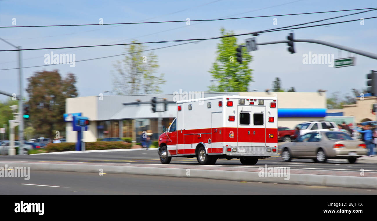 Ambulance speeding past traffic on an American street heading to an ...