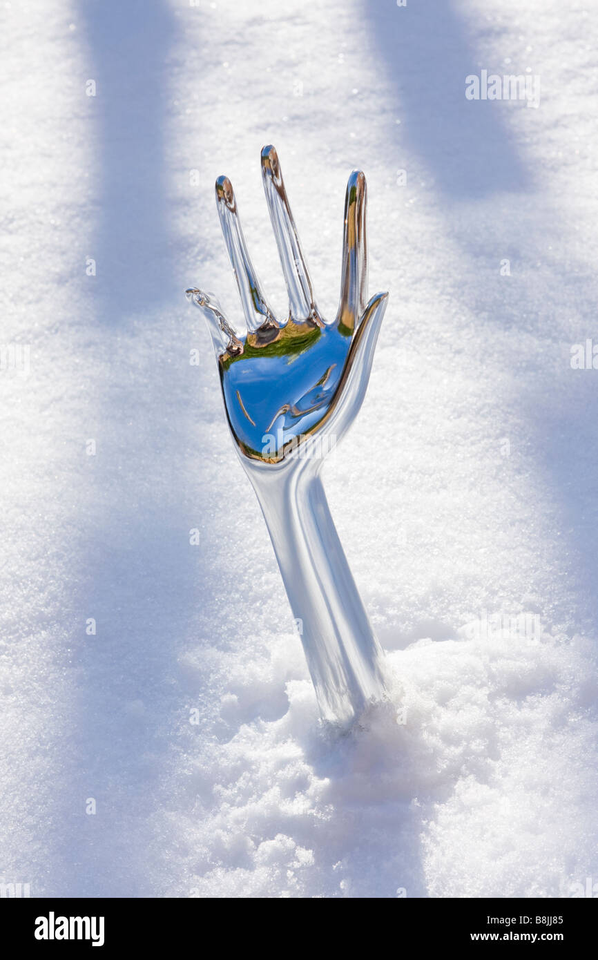 Metallic chrome hand reaching out from beneath snow Stock Photo - Alamy
