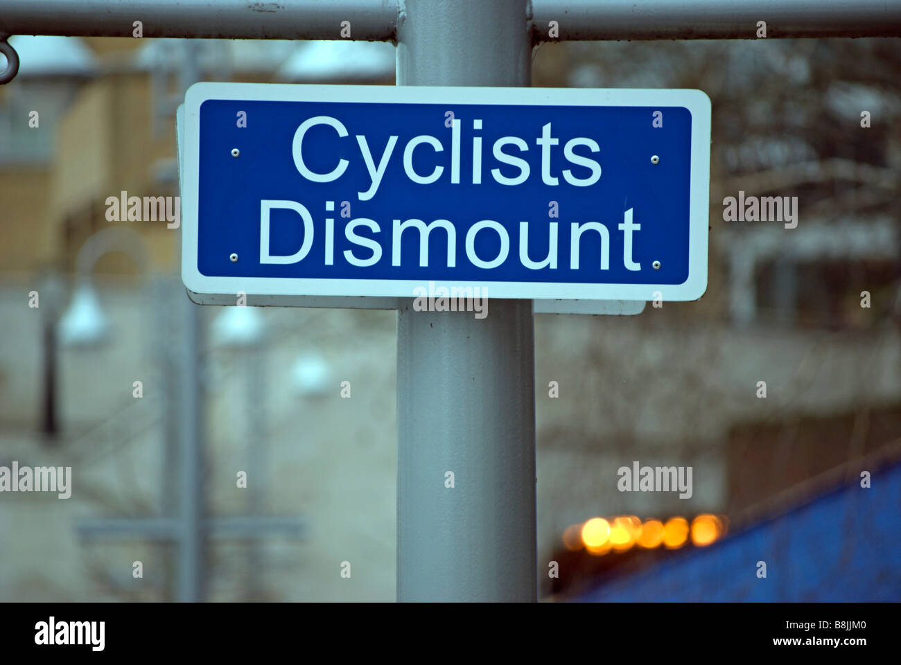 british blue and white cyclists dismount sign mouted ona pole, in ...