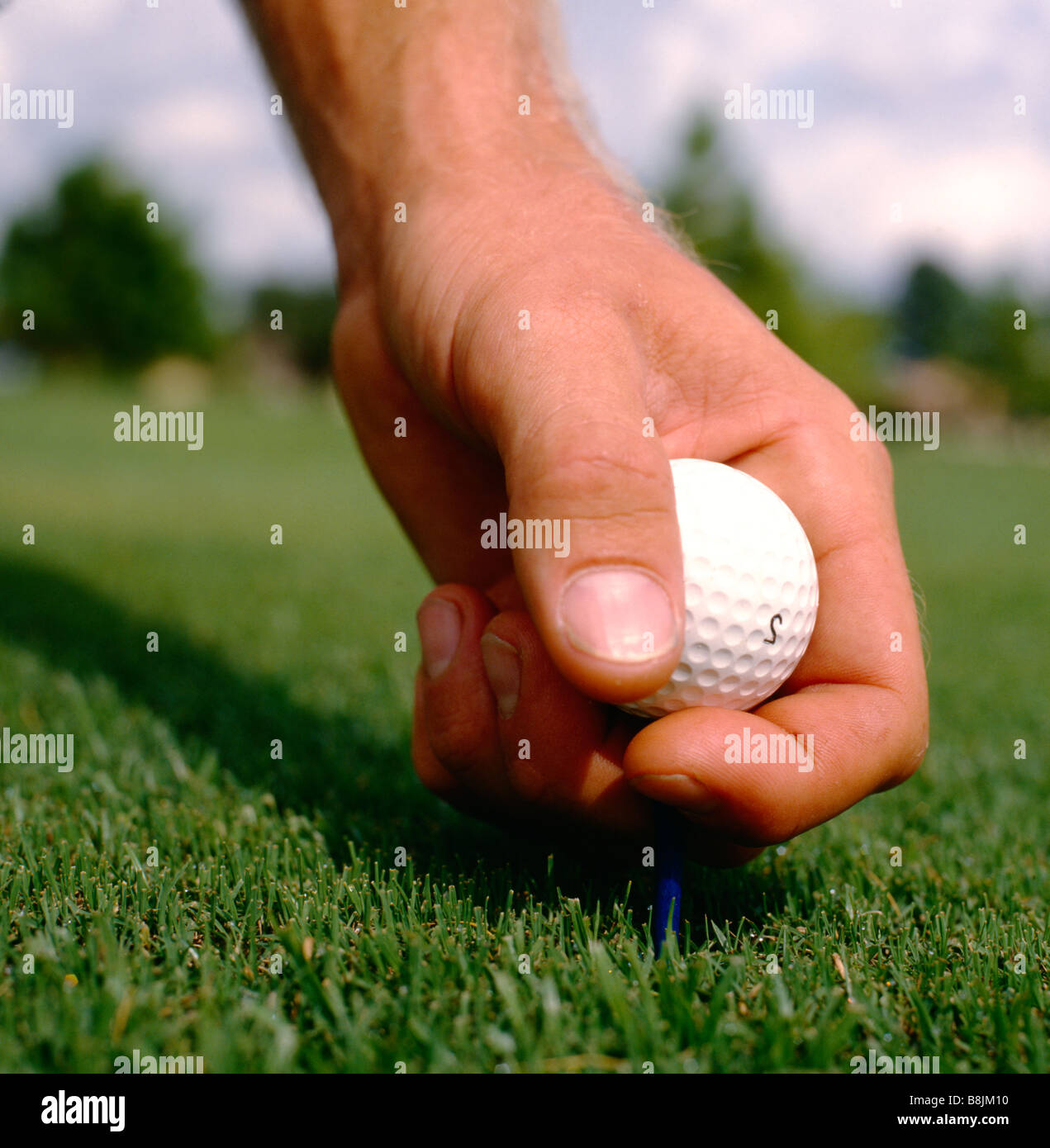 Hand with golf ball Stock Photo - Alamy