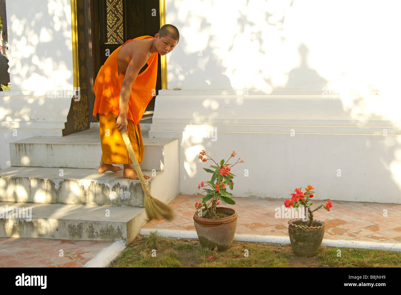 Buddhist monk sweeping hi-res stock photography and images - Alamy
