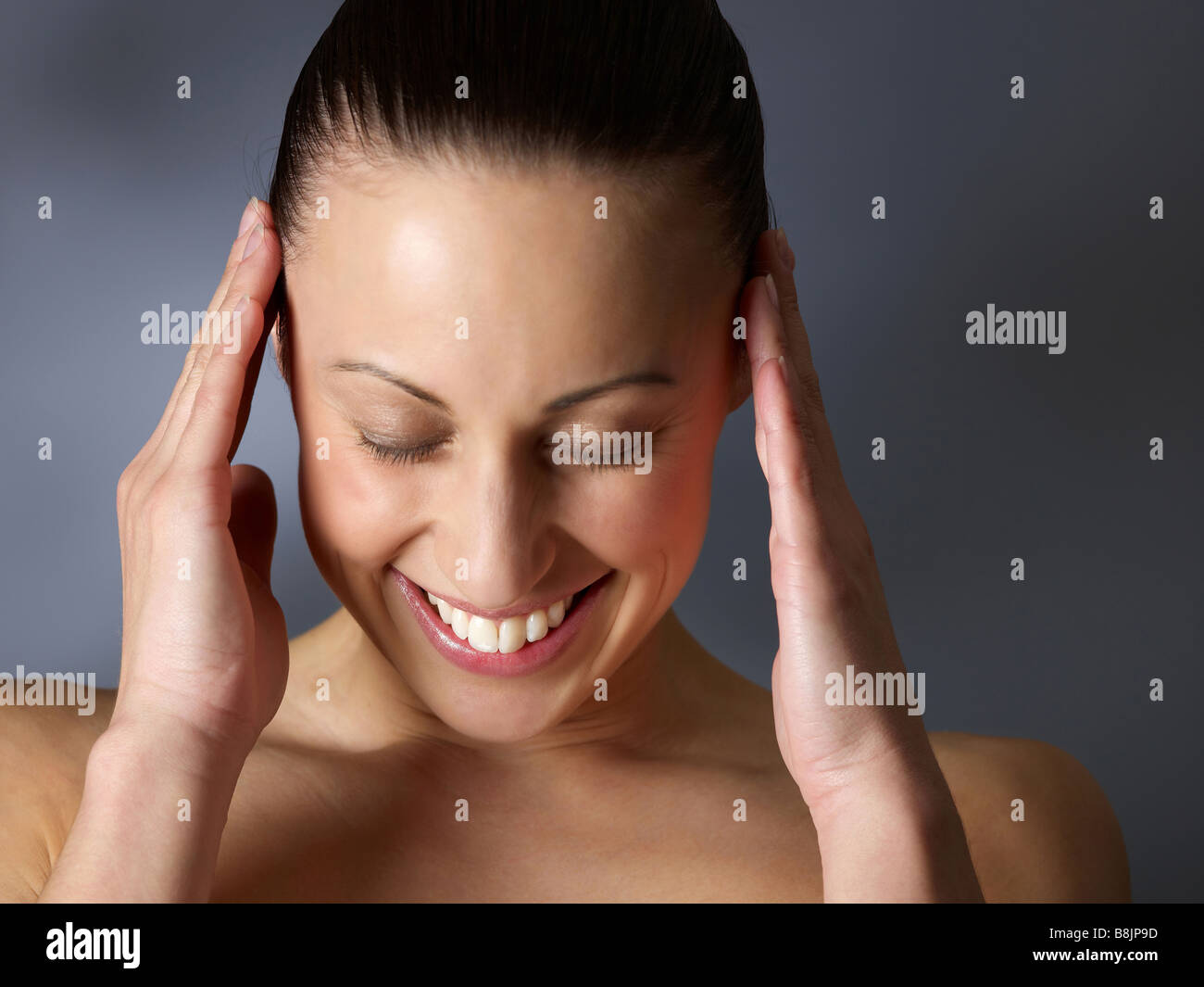 Girl in touching her temples Stock Photo - Alamy