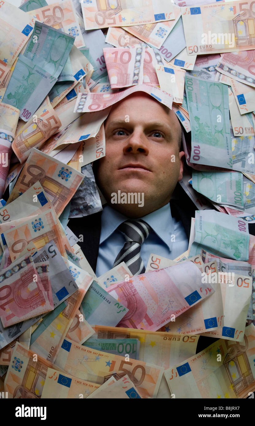 Banker in a suit with al lot of Euro money Stock Photo - Alamy