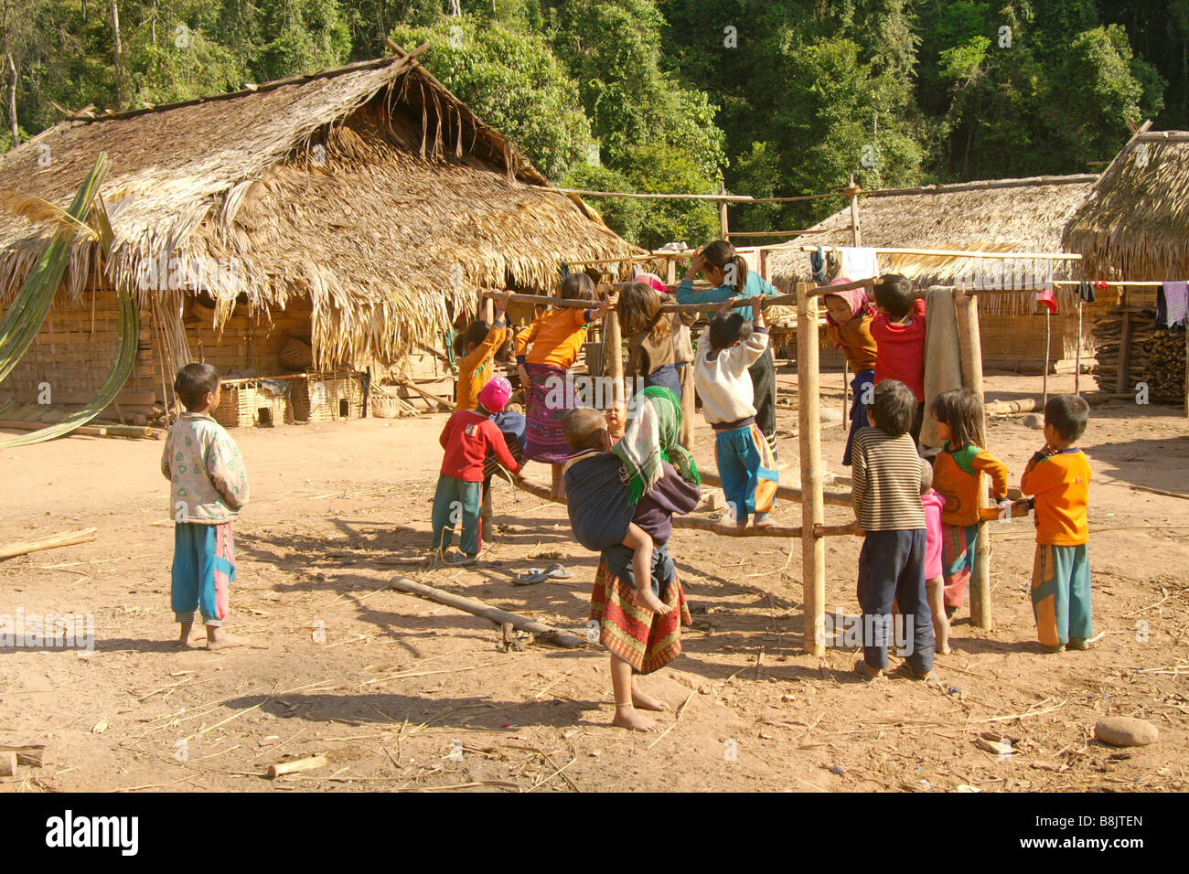 Akha children playing in hilltribe village, Namtha region of northern ...