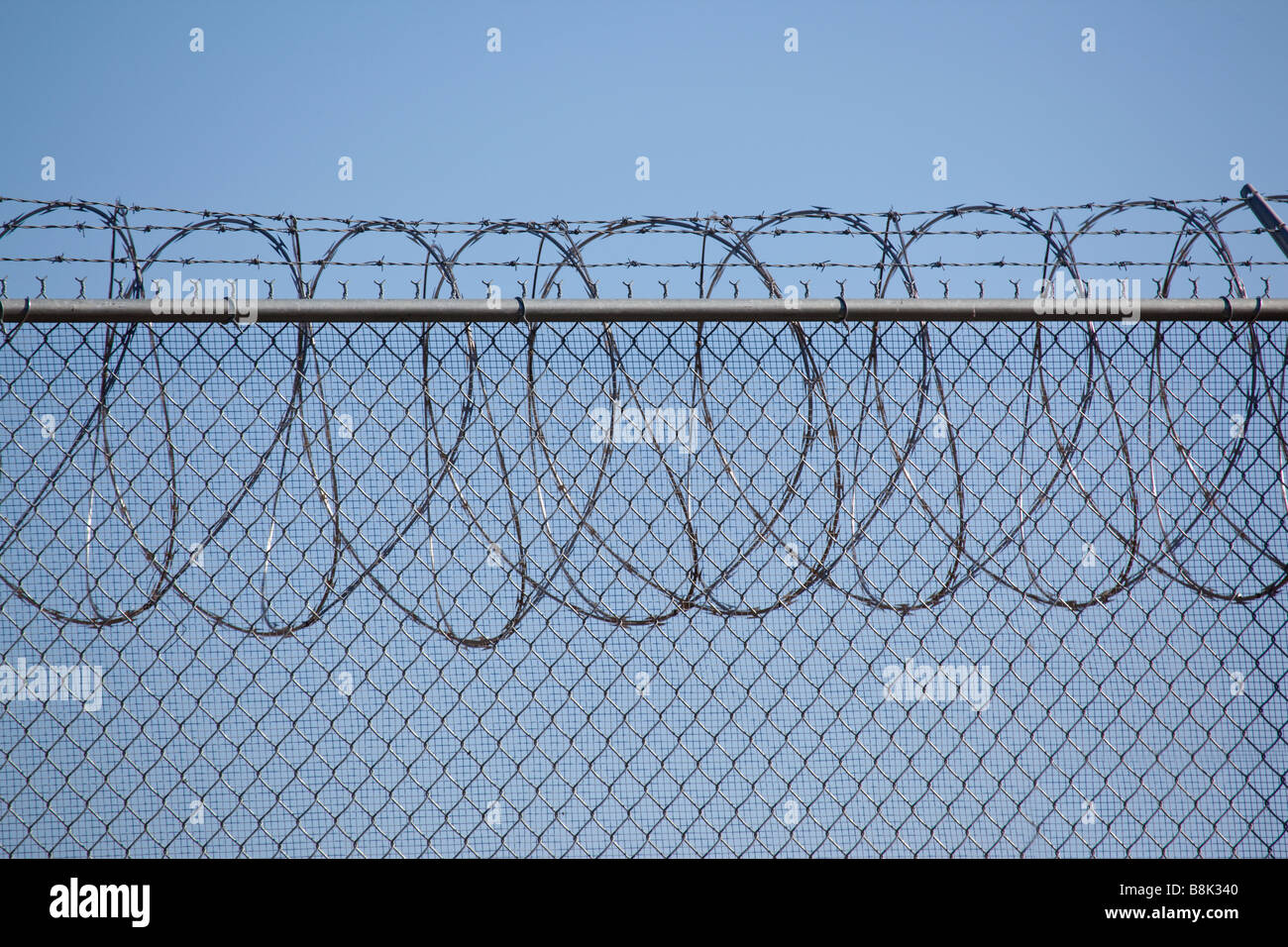 Barbed wire security fence surrounding a detention center Stock Photo ...