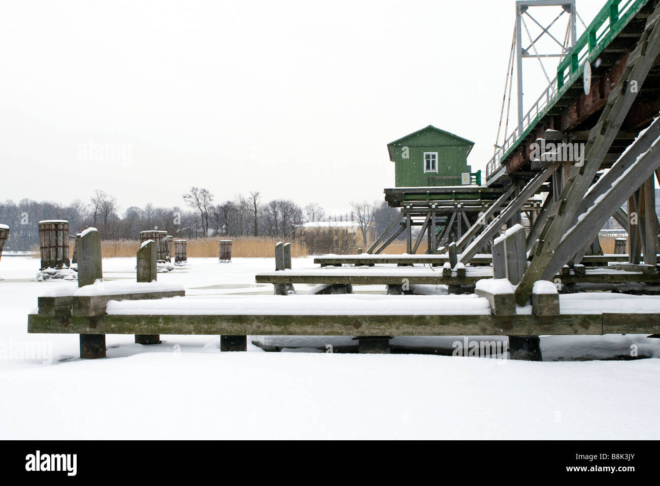 Frozen river bridge wooden piers construction view Stock Photo - Alamy