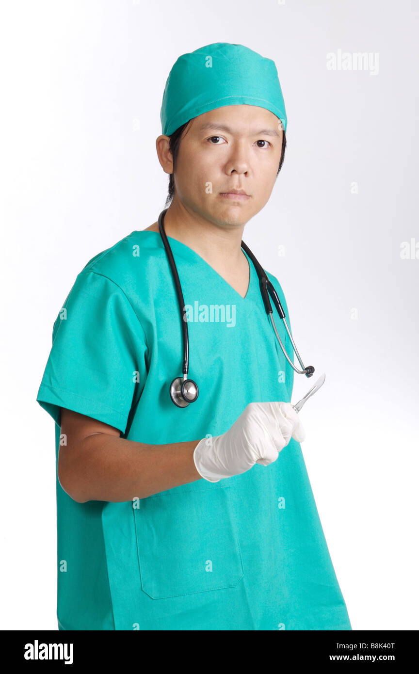 Doctor in operating gown with a scalpel in hand Stock Photo - Alamy