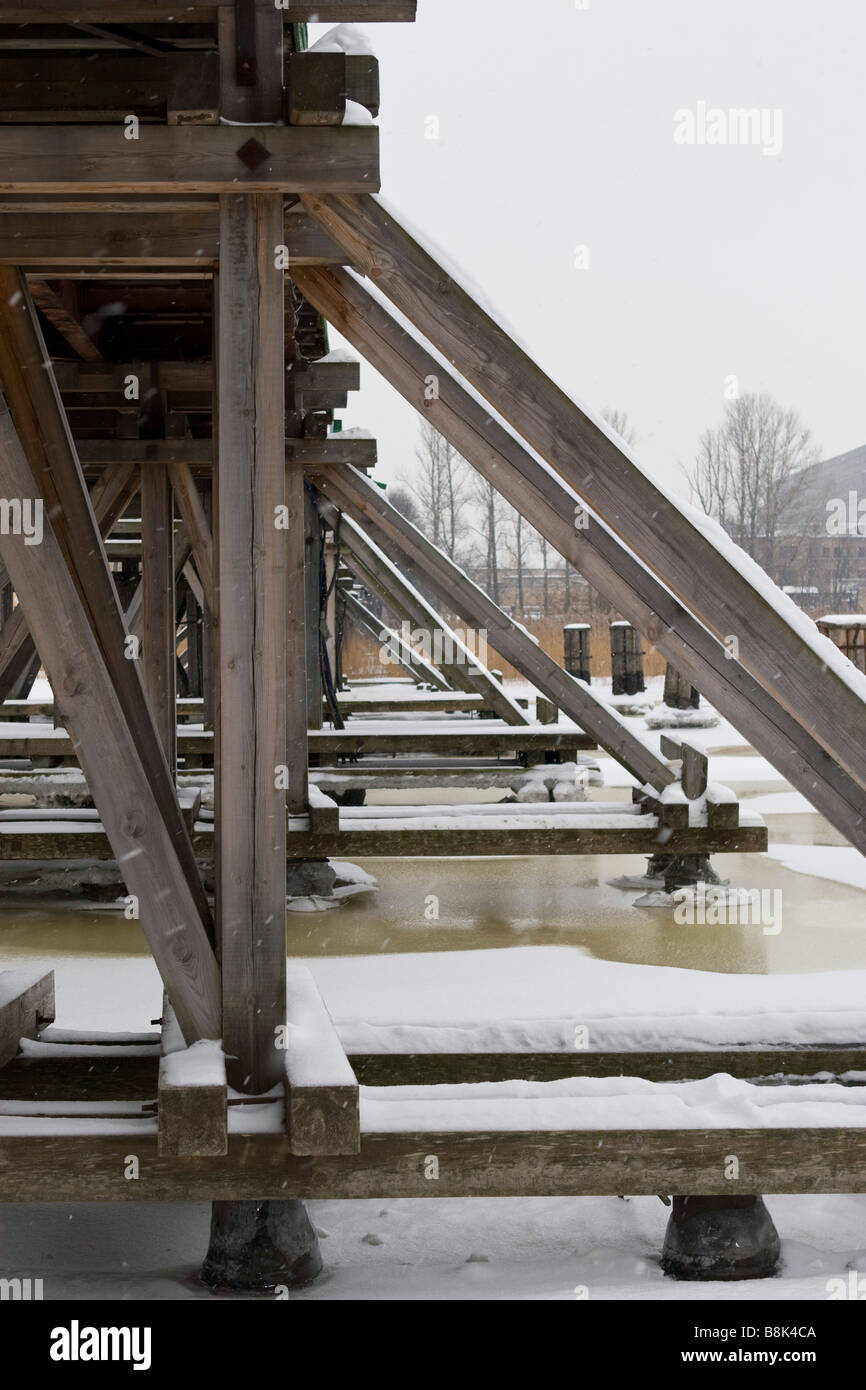 Frozen river bridge wooden piers construction view Stock Photo - Alamy