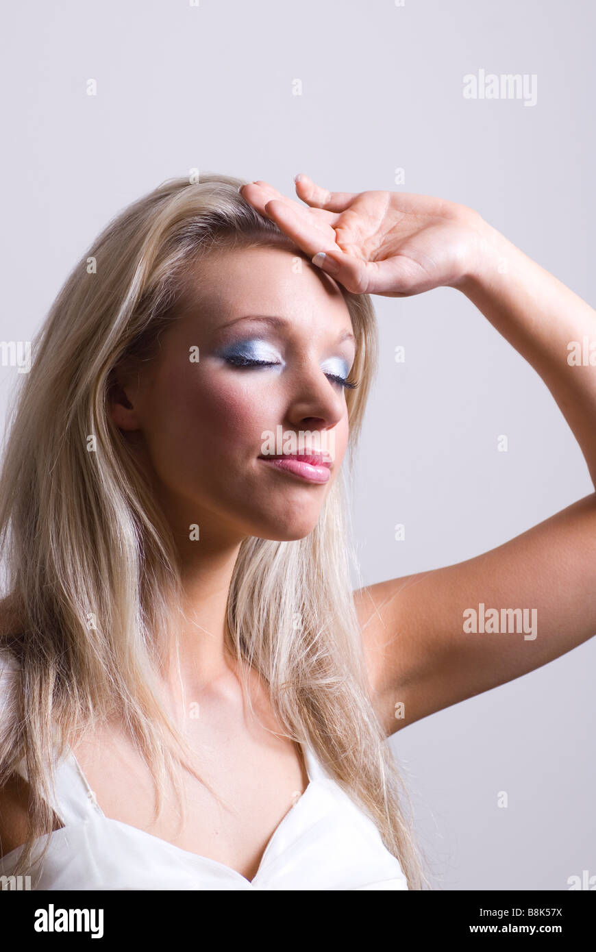 Young woman hand on head Stock Photo - Alamy