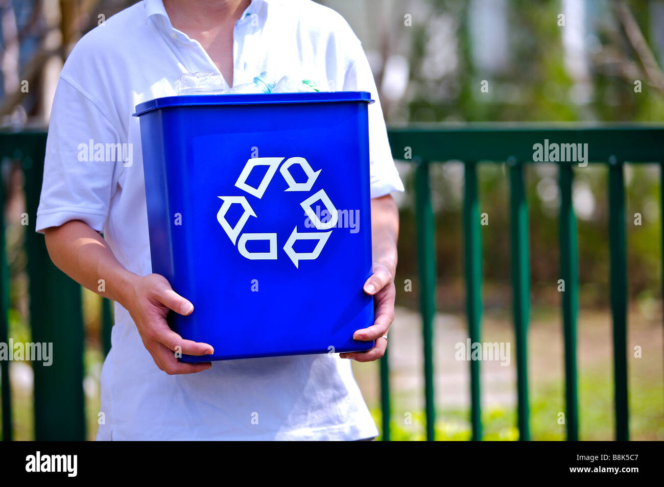 Man holding a recycling bin Stock Photo - Alamy