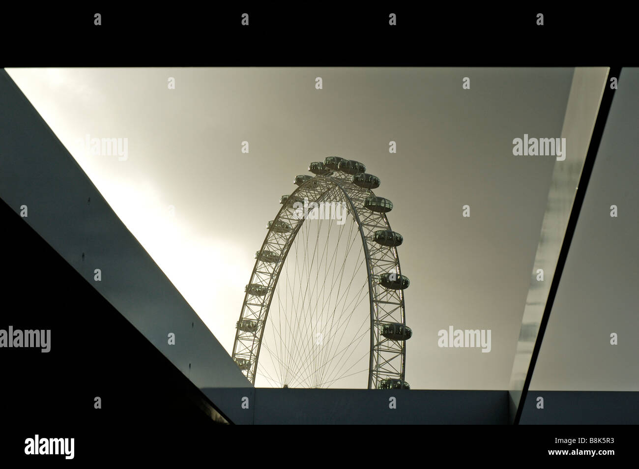 The London Eye viewed from the South Bank framed by architecture Stock ...
