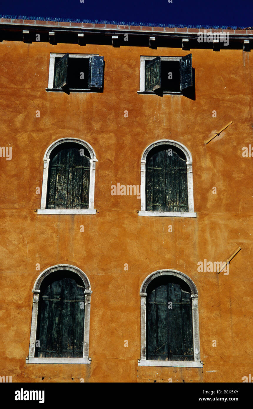 House wall Painted plaster Ochre dark orange Shuttered windows VENICE ...