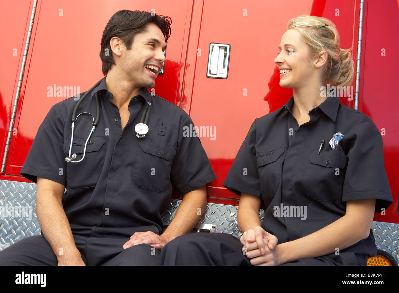 Two paramedics laughing together Stock Photo - Alamy