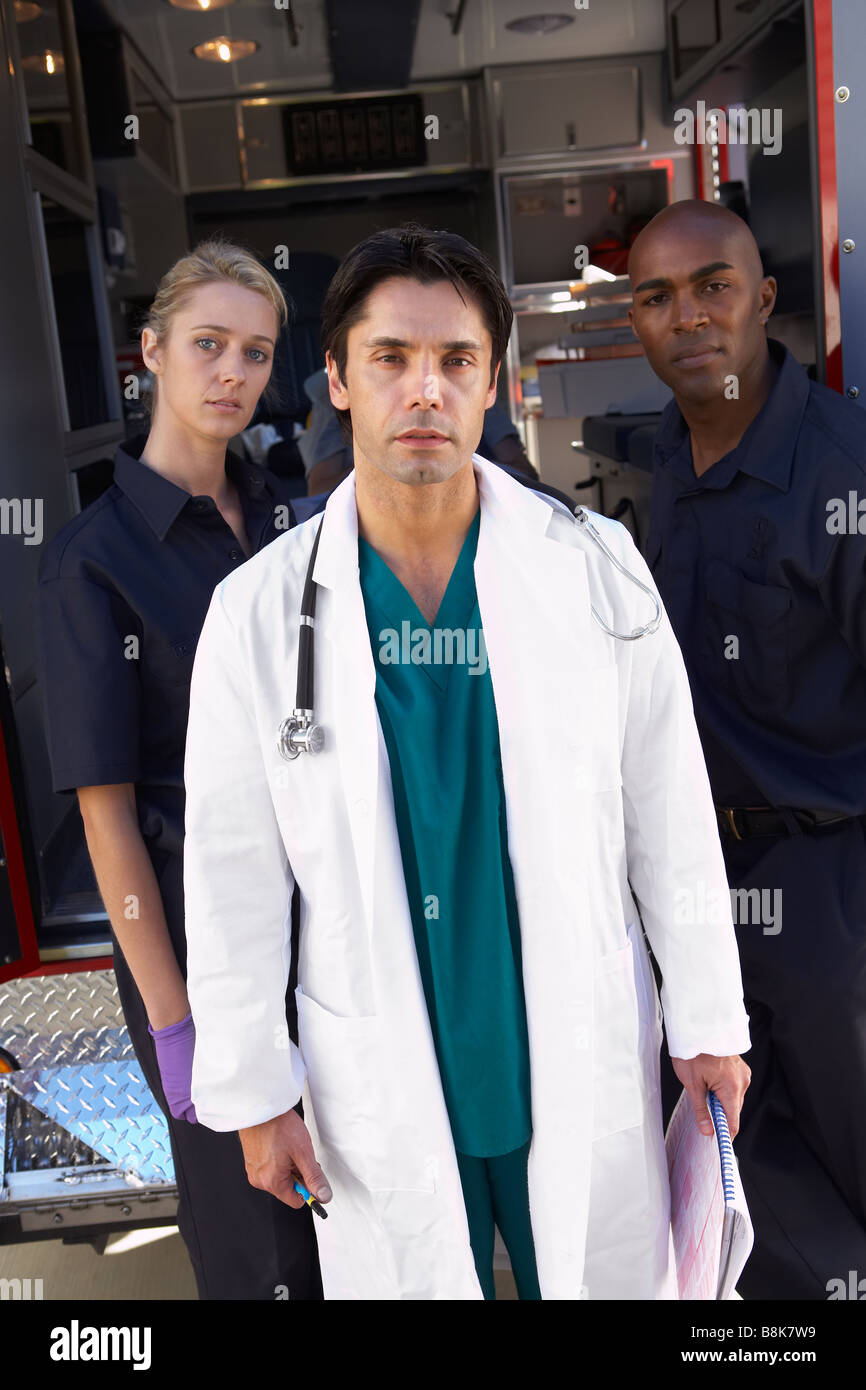 Portrait of doctor with two paramedics in front of ambulance Stock ...