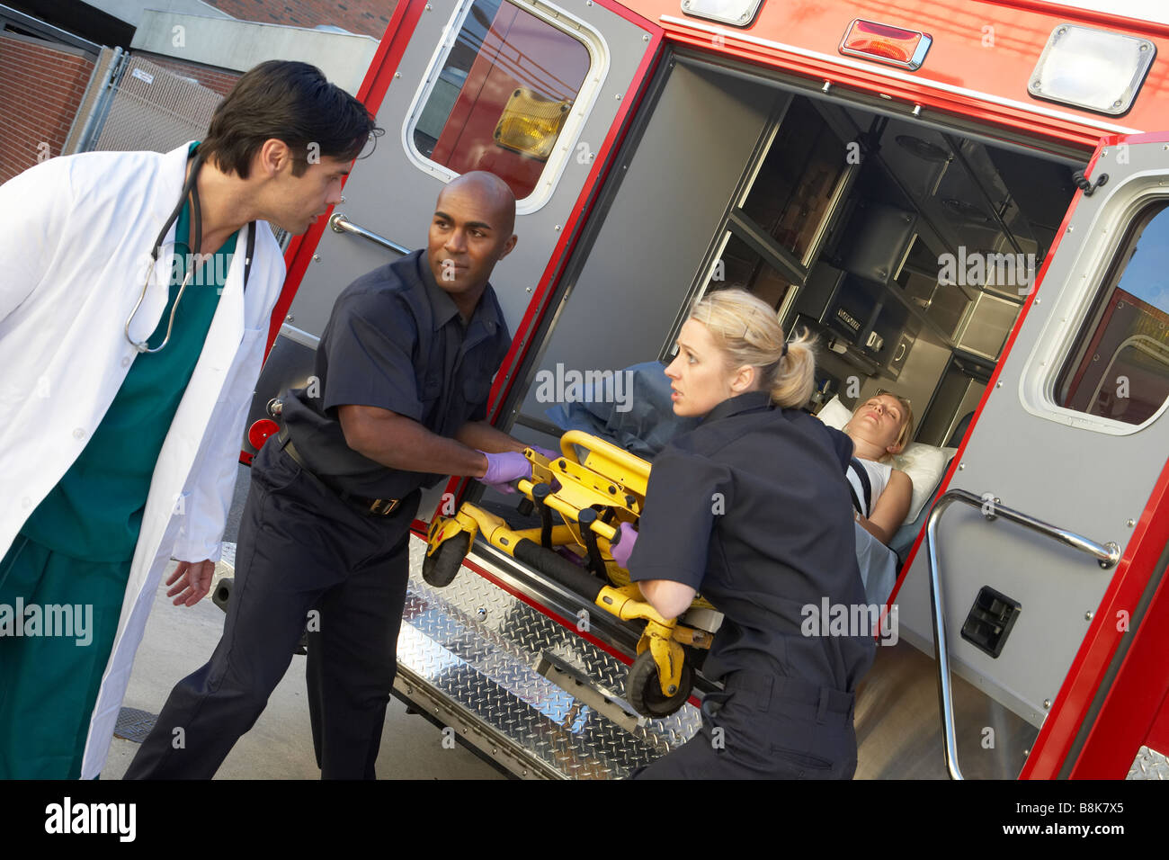 Paramedics and doctor unloading patient from ambulance Stock Photo - Alamy