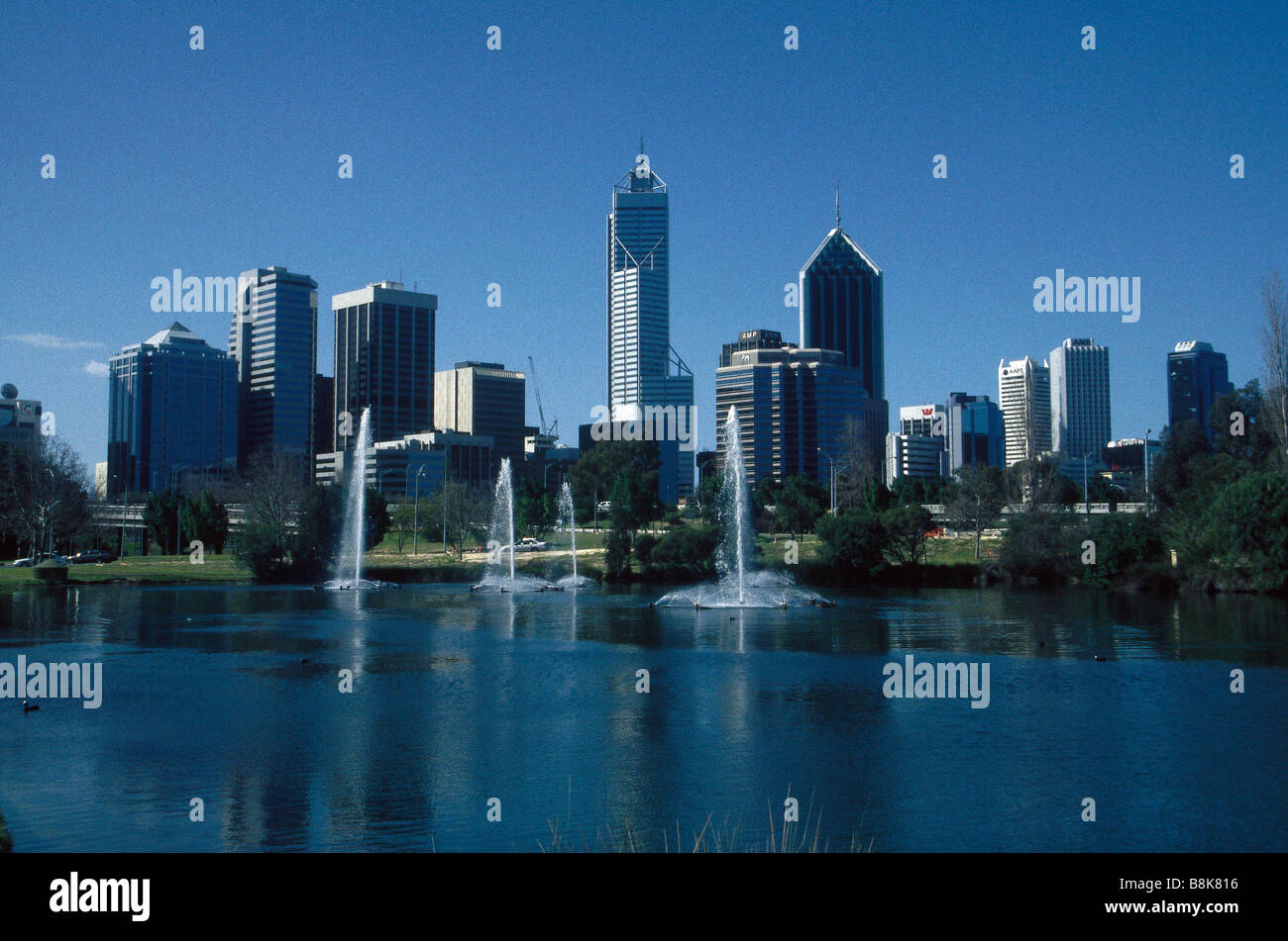 View across lake Water jets City skyline Cityscape Modern buildings ...