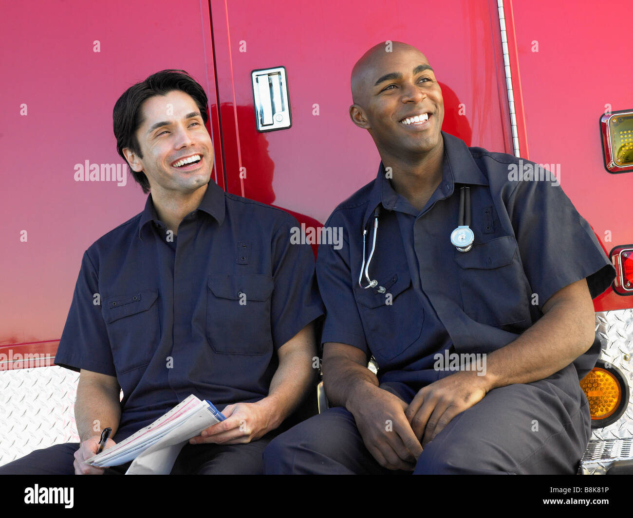 Paramedics talking by ambulance hi-res stock photography and images - Alamy
