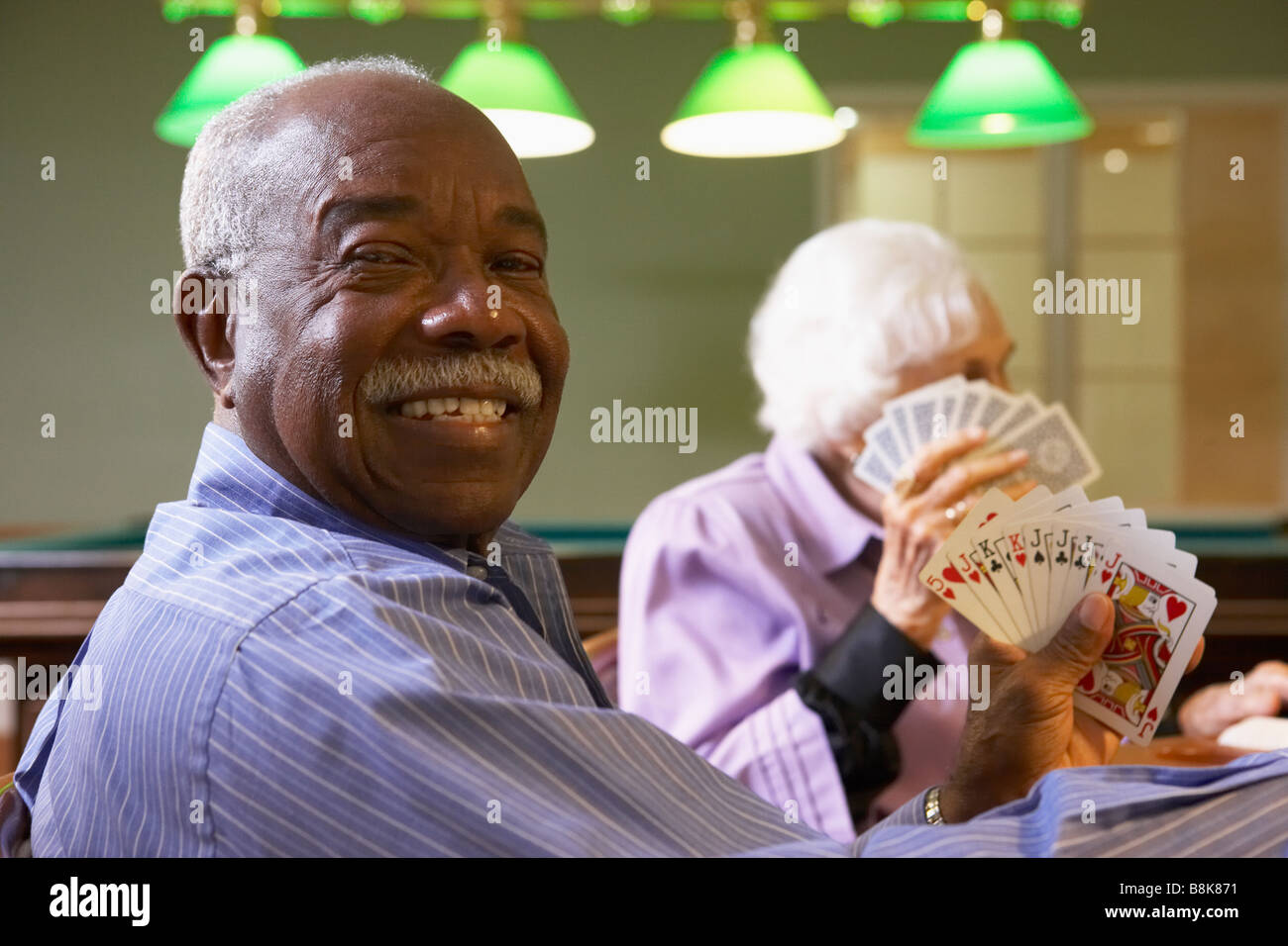 Senior man playing bridge Stock Photo - Alamy