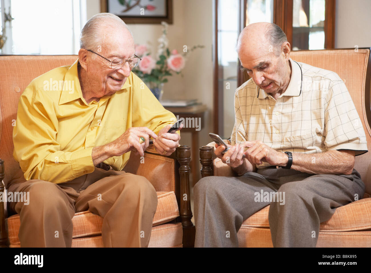 Senior men text messaging Stock Photo - Alamy
