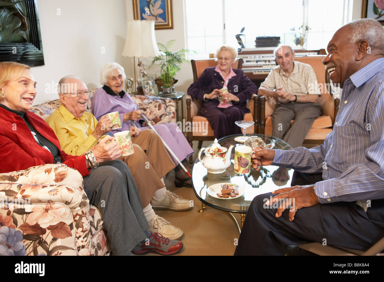 Senior adults having morning tea together Stock Photo - Alamy