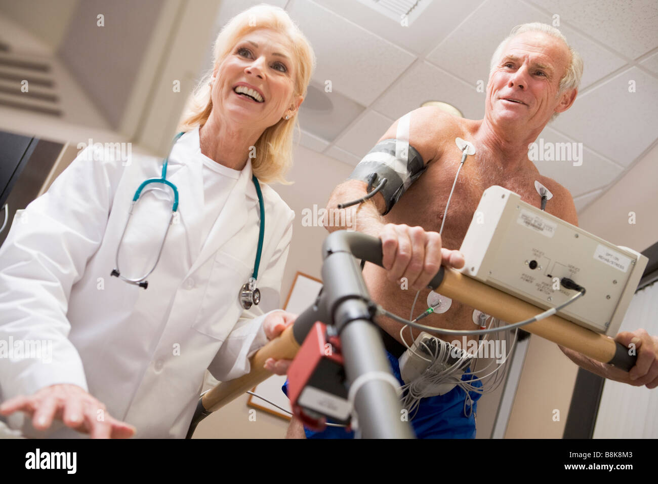 Doctor Monitoring The Heart-Rate Of Patient On A Treadmill Stock Photo ...