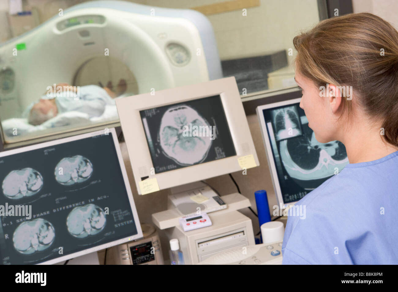 Nurse Monitoring Patient Having A Computerized Axial Tomography (CAT ...