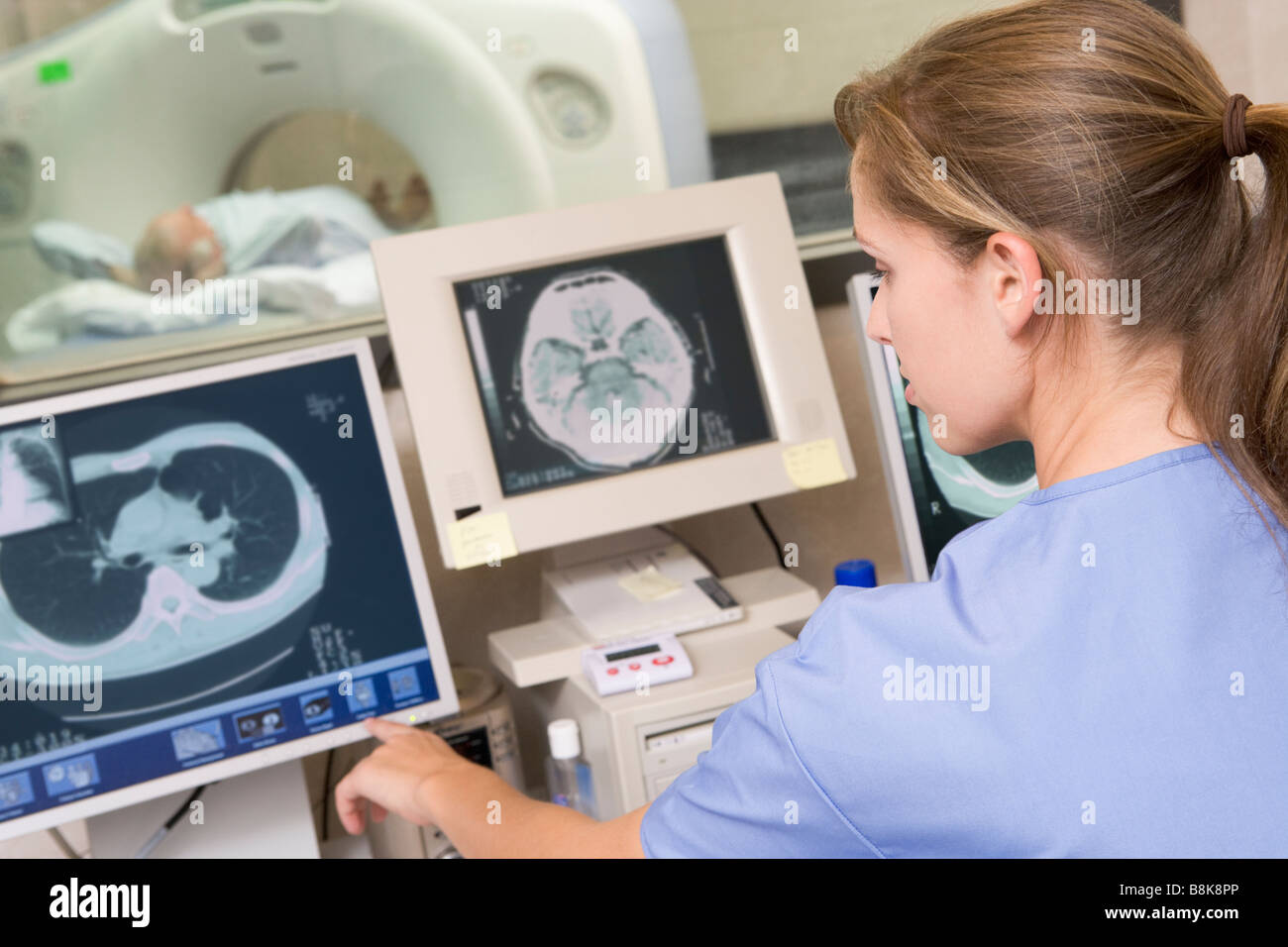 Nurse Monitoring Patient Having A Computerized Axial Tomography (CAT ...