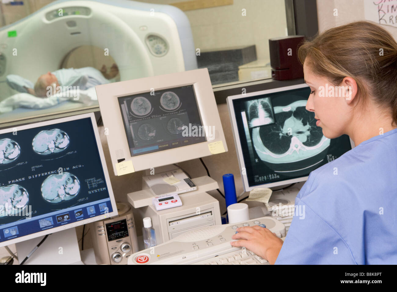 Nurse Monitoring Patient Having A Computerized Axial Tomography (CAT ...