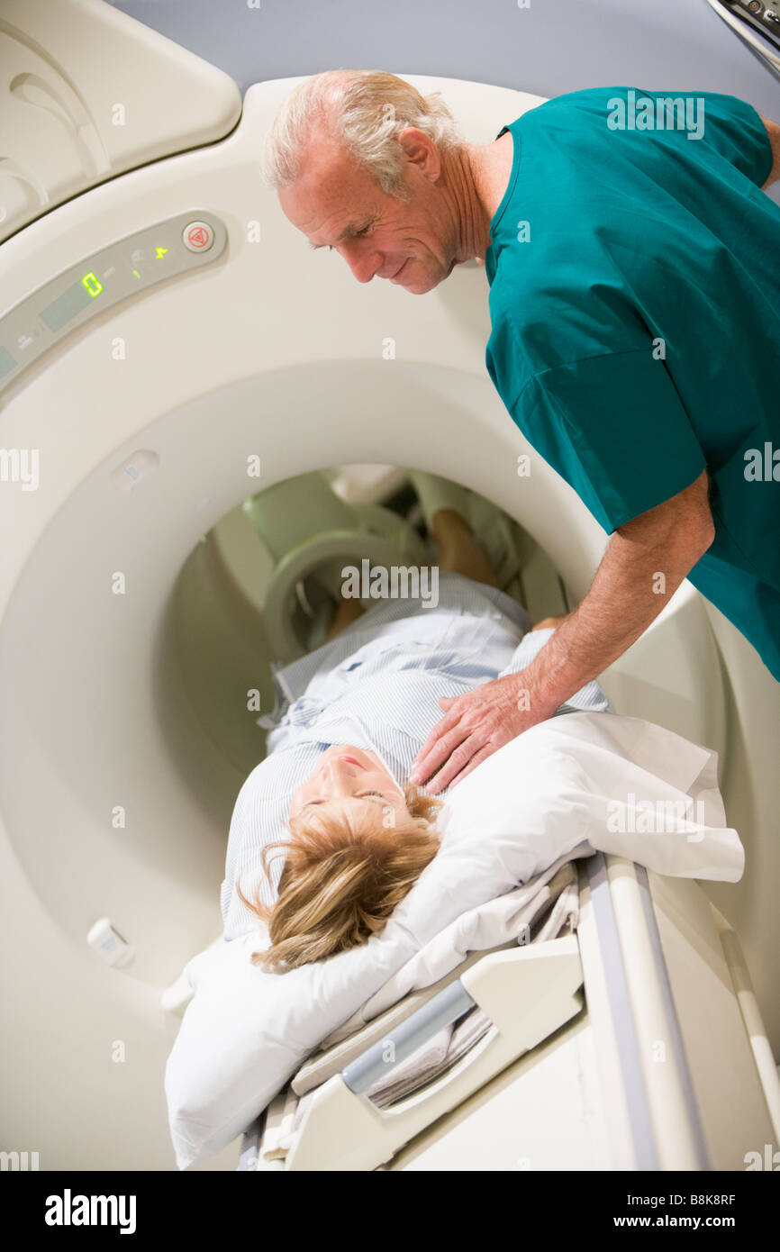 Doctor With Patient As They Prepare For A Computerized Axial Tomography ...