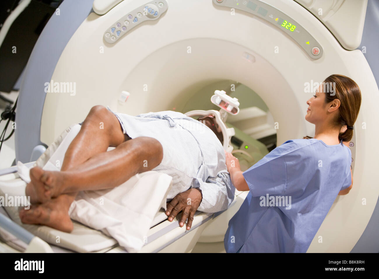 Nurse With Patient As They Prepare For A Computerized Axial Tomography ...