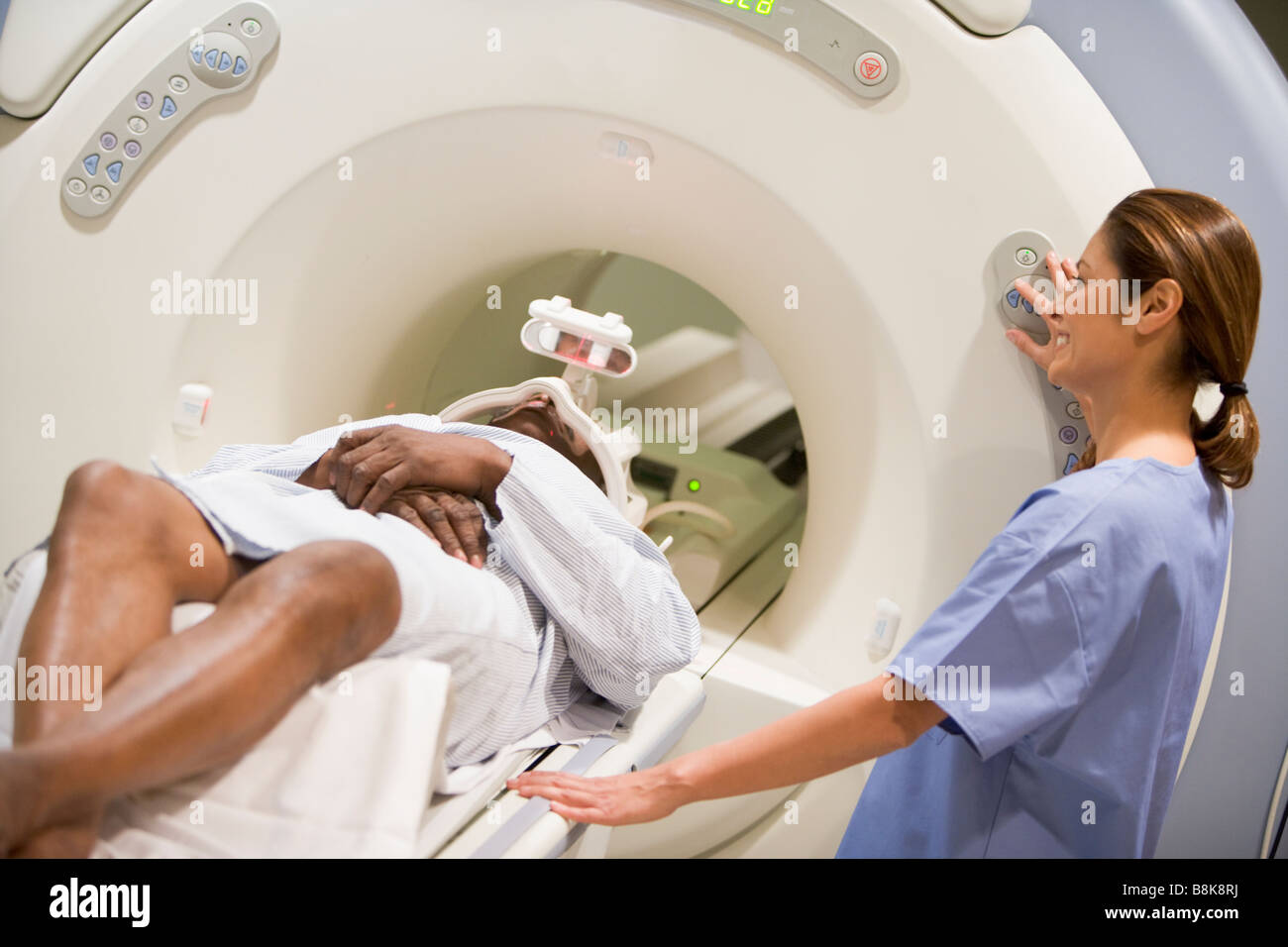 Nurse With Patient As They Prepare For A Computerized Axial Tomography ...
