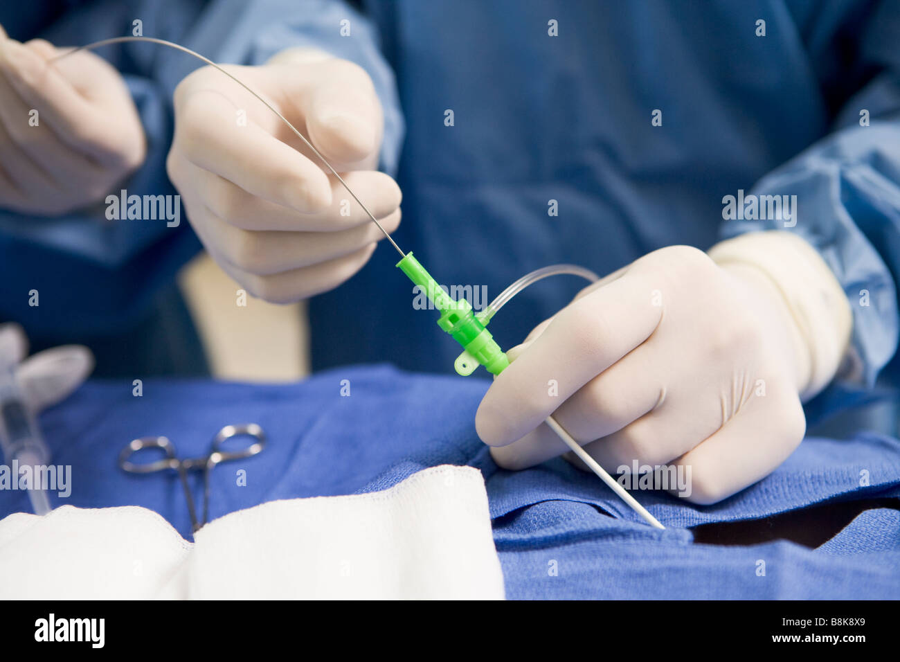 Surgeon Inserting Tube Into Patient During Surgery Stock Photo - Alamy
