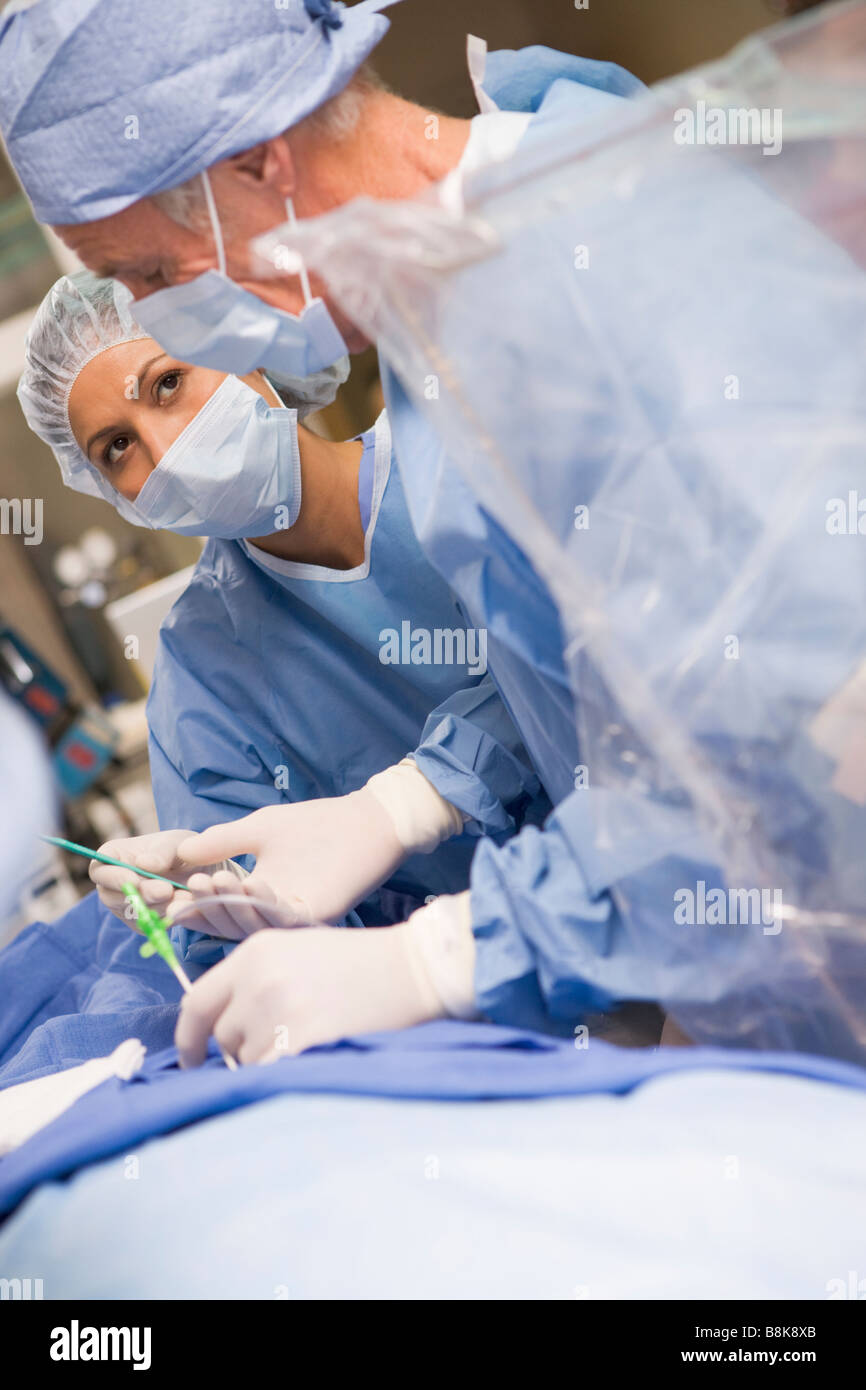 Surgeons Operating On Patient Stock Photo - Alamy