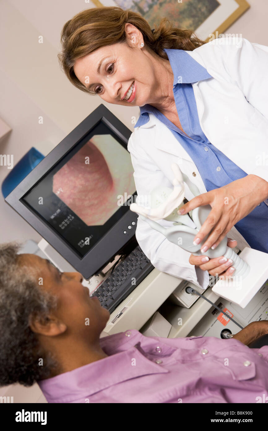 Doctor Performing Check-Up On Patient Stock Photo - Alamy
