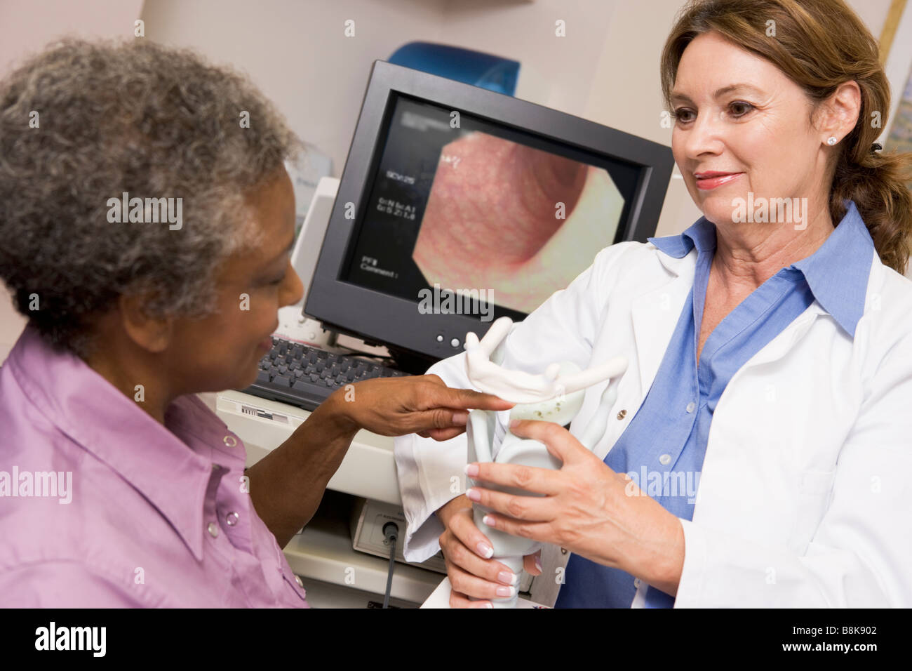 Doctor Performing Check-Up On Patient Stock Photo - Alamy