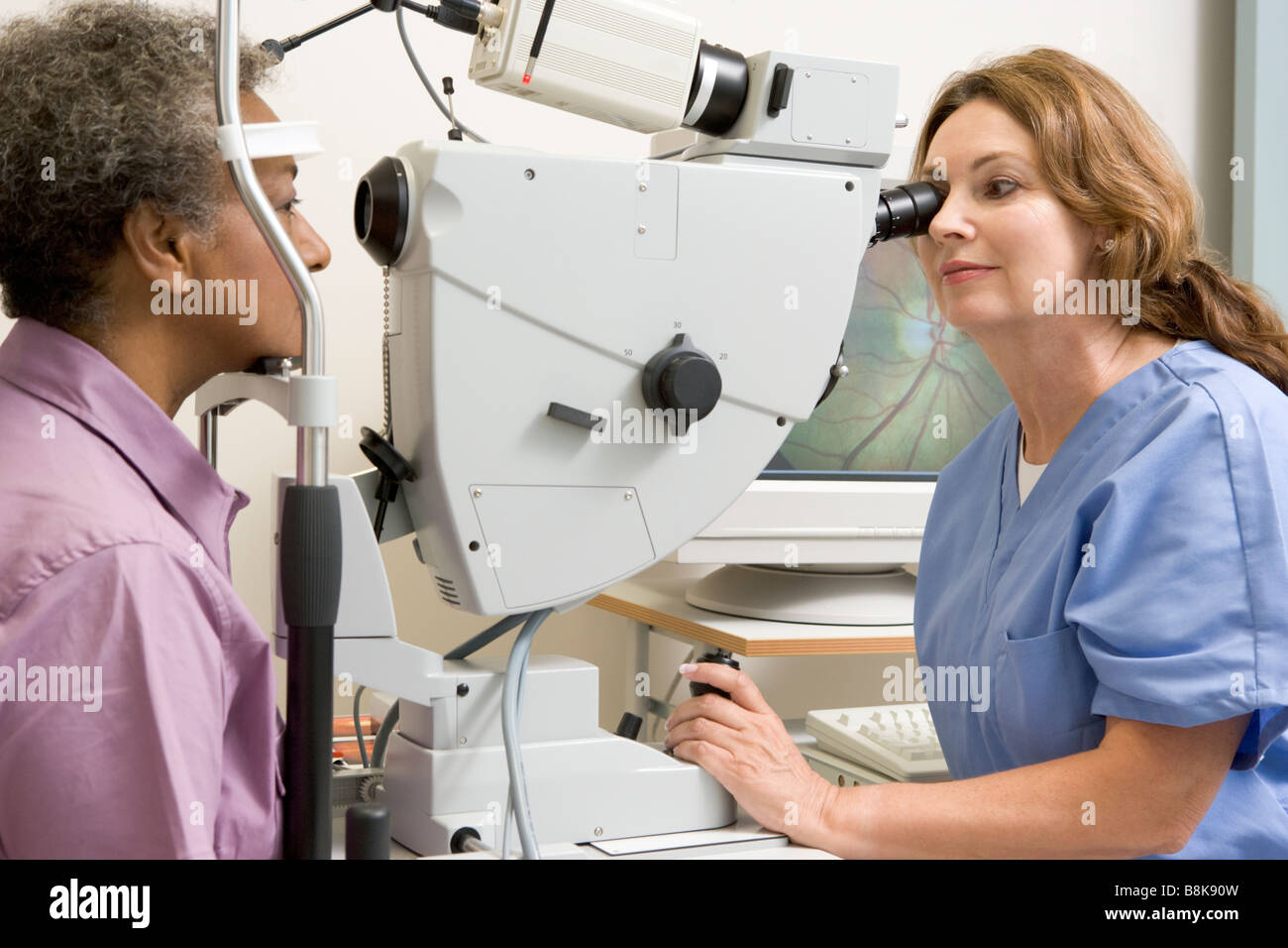 Nurse Checking Patient's Eyes Stock Photo - Alamy
