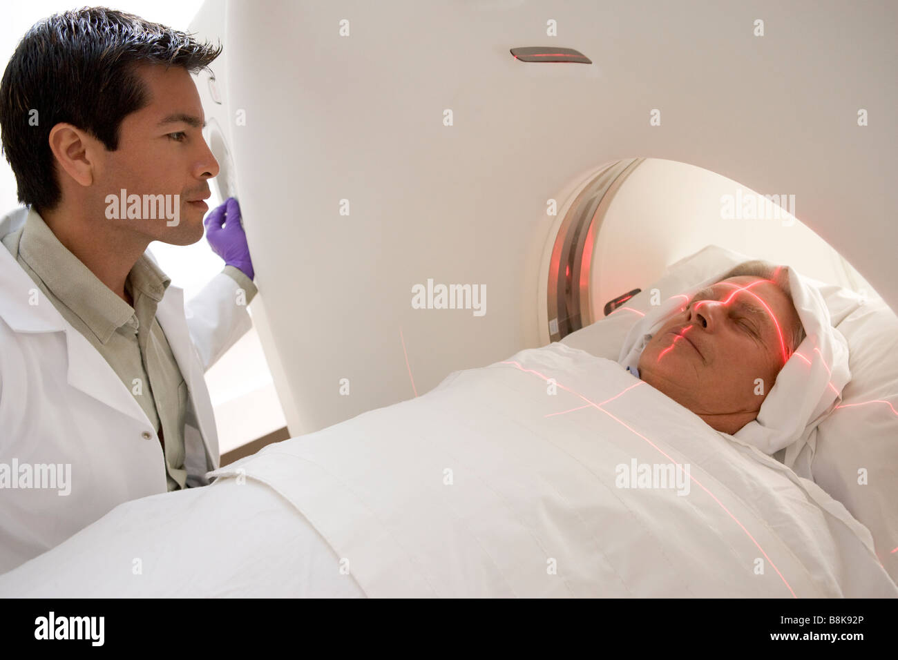 Doctor With Patient Having A Computerized Axial Tomography (CAT) Scan ...