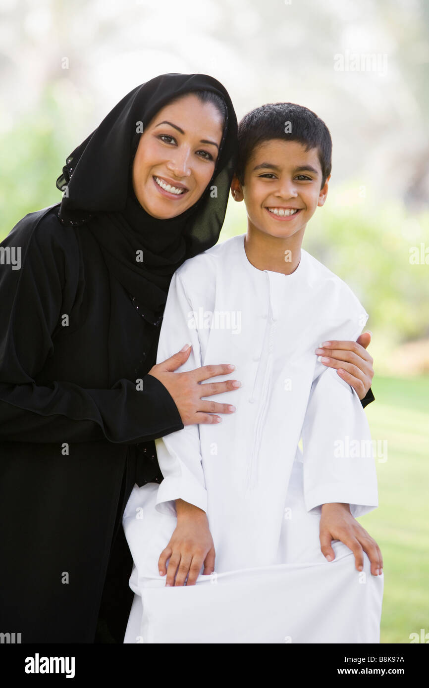 Woman and young boy outdoors in a park smiling (selective focus Stock ...