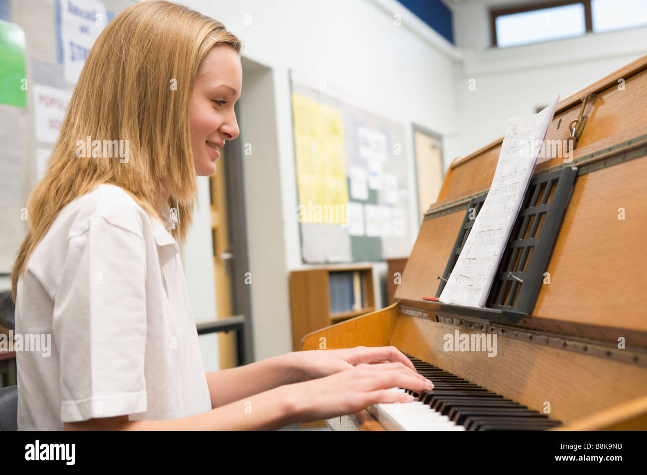 Female student learning piano in classroom Stock Photo - Alamy