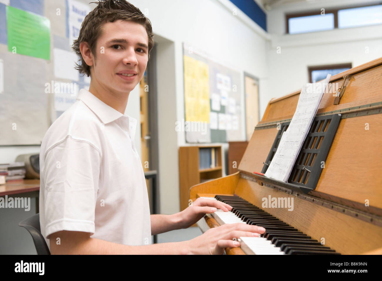 Male student learning piano in classroom Stock Photo - Alamy