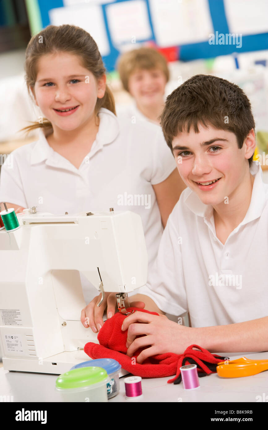Male and female student using sewing machine Stock Photo - Alamy
