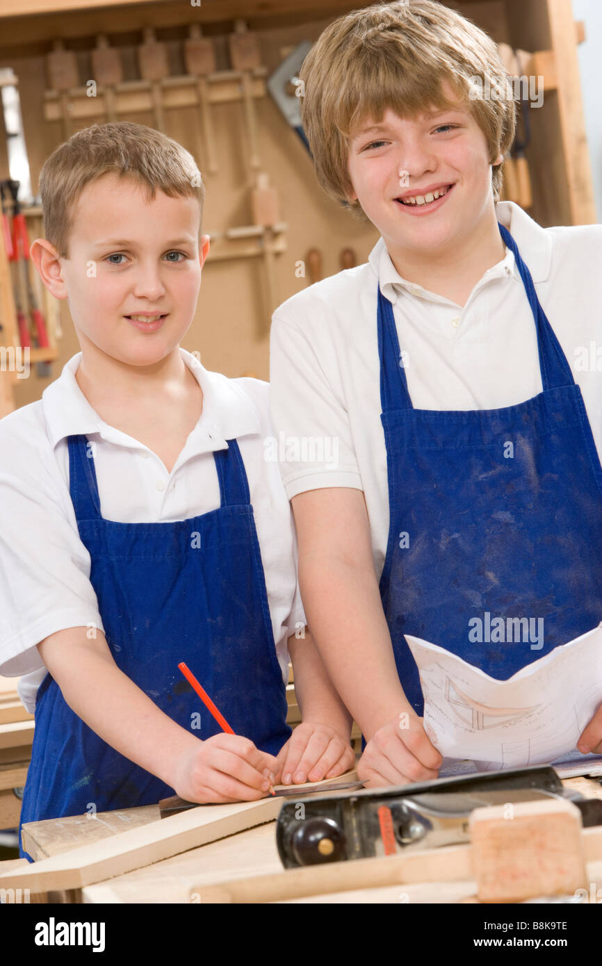 Male students reviewing woodworking plans Stock Photo - Alamy