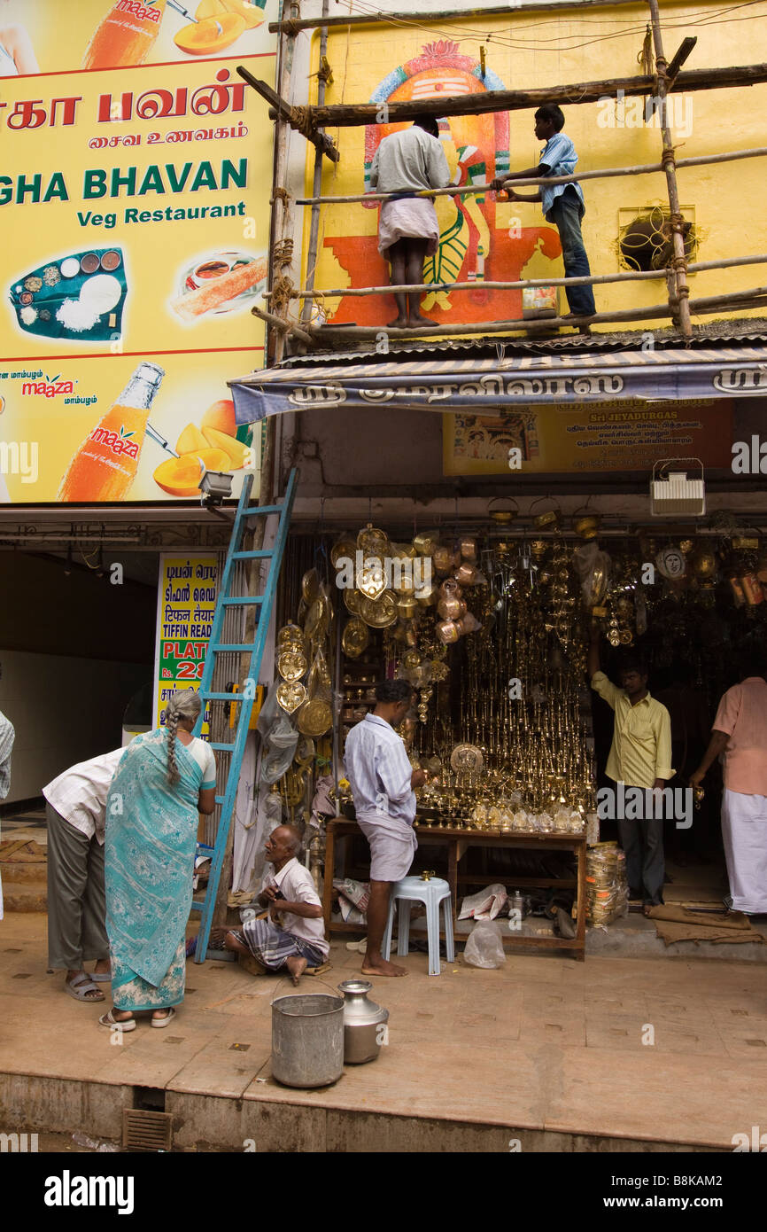 India Tamil Nadu Madurai men painting new sign above souvenir shop ...